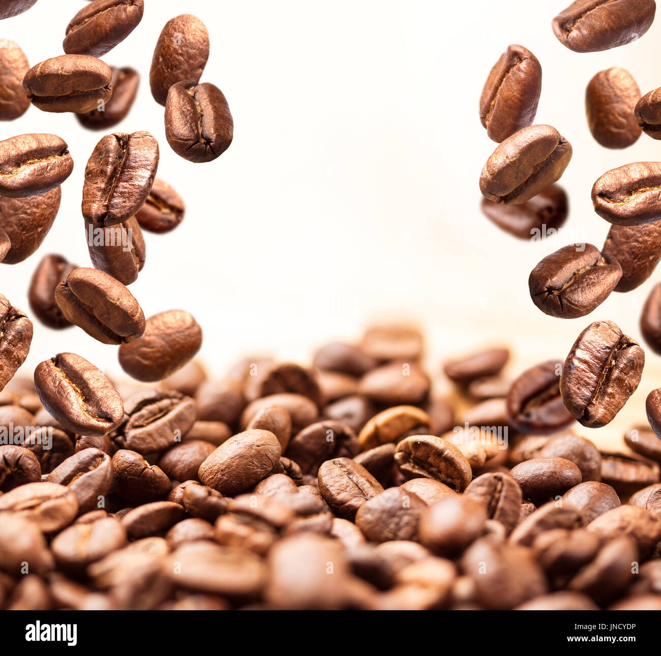 Flying coffee beans on white Stock Photo - Alamy