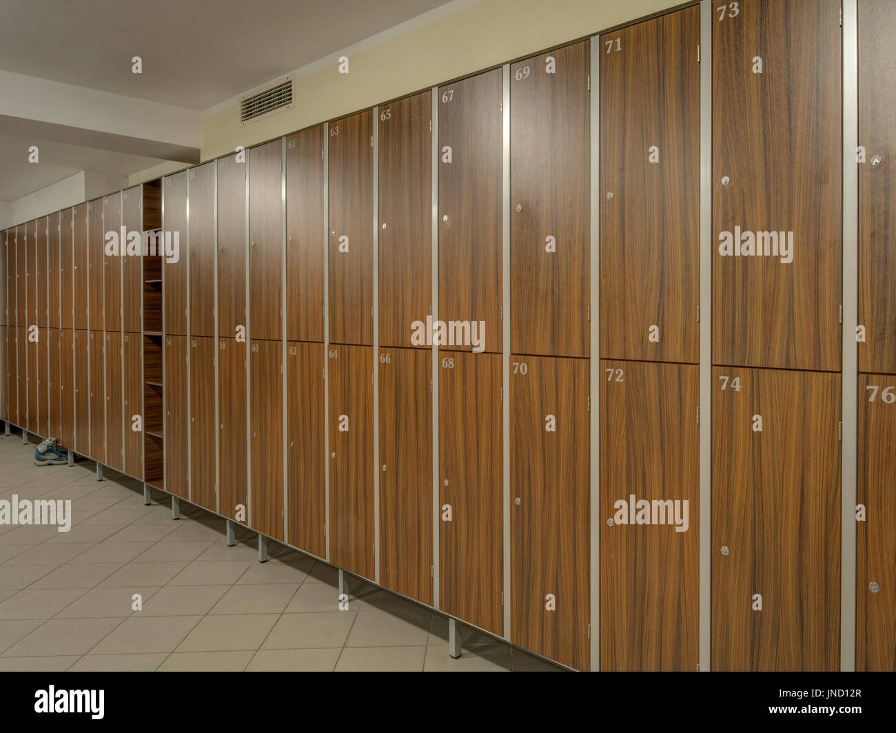 The row of wooden cabinets in a fitness club dressing room Stock Photo ...