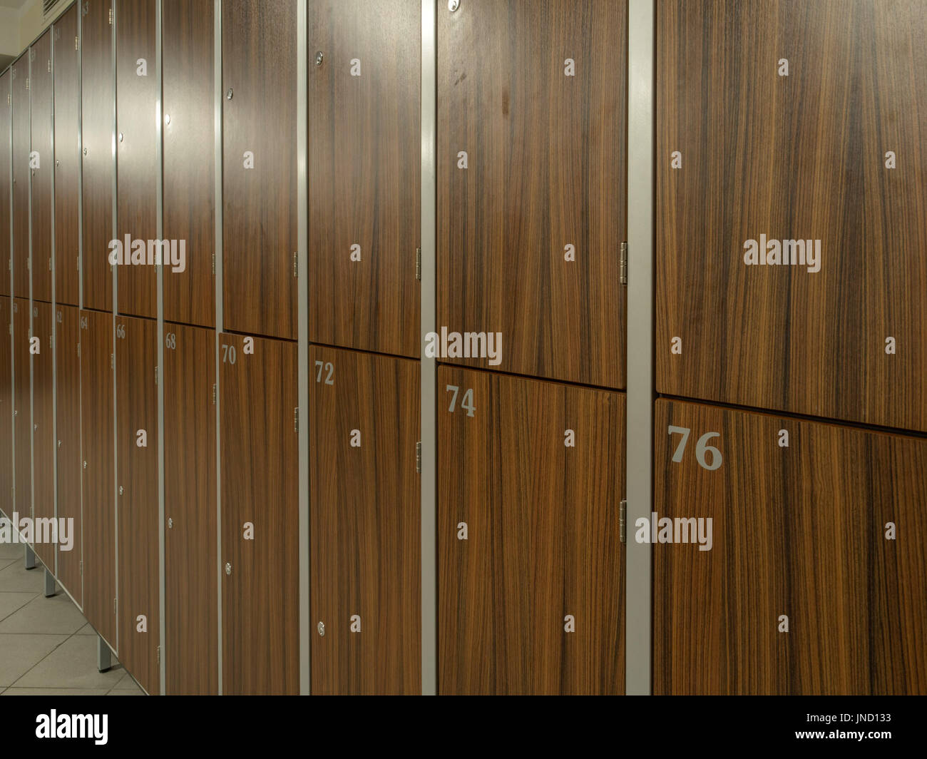 The row of wooden cabinets in a fitness club dressing room Stock Photo ...