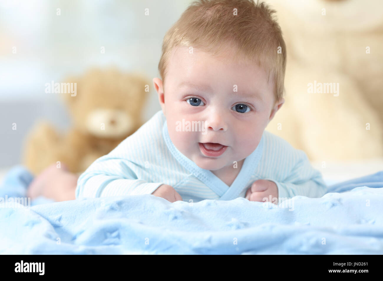 Front view portrait of a happy baby looking at you on a bed Stock Photo ...