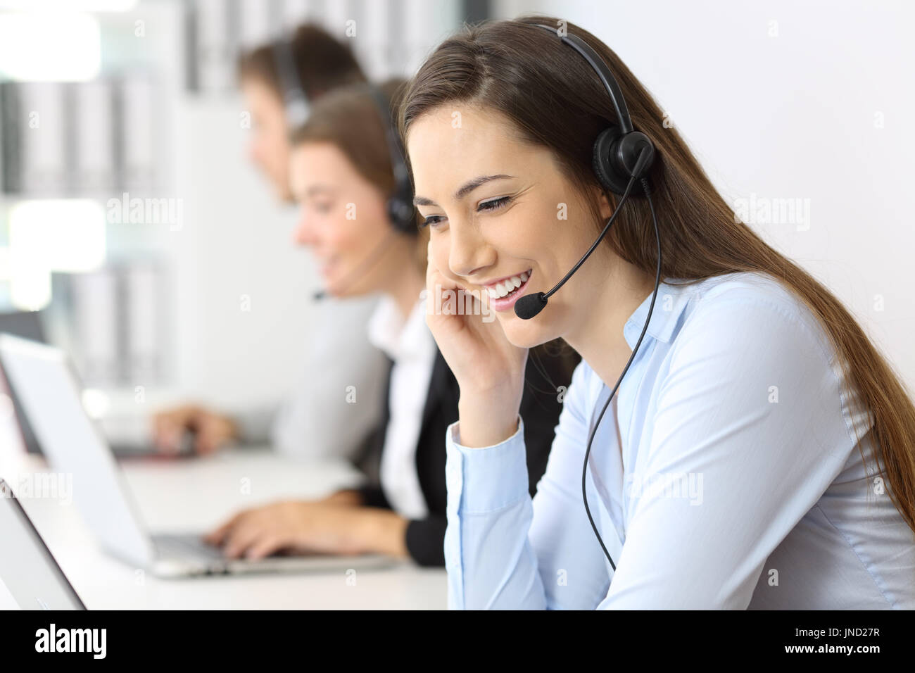 Telemarketing operator talking working at office with other workers in ...
