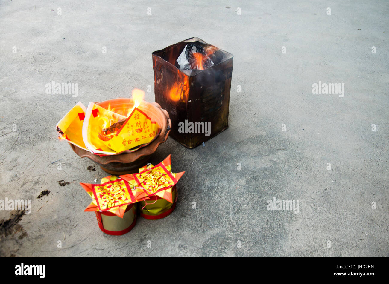 People burn joss paper gold and silver paper for worship with paper ...