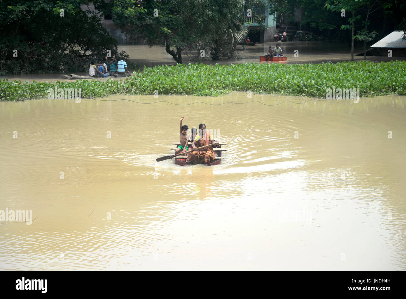 Ghatal, India. 29th July, 2017. Woman with children crossed the ...