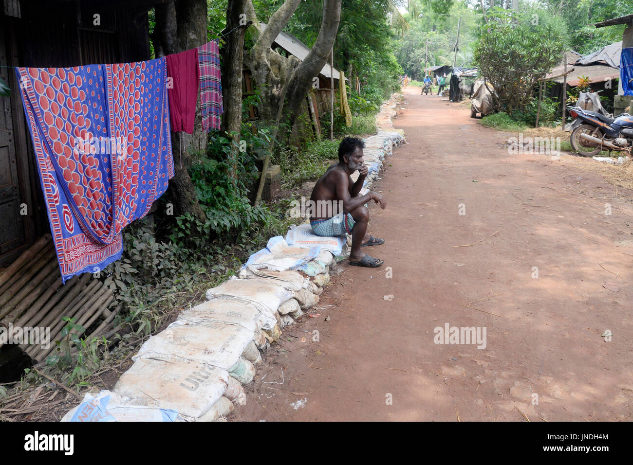 Ghatal, India. 29th July, 2017. Elderly man sits in river dam of ...