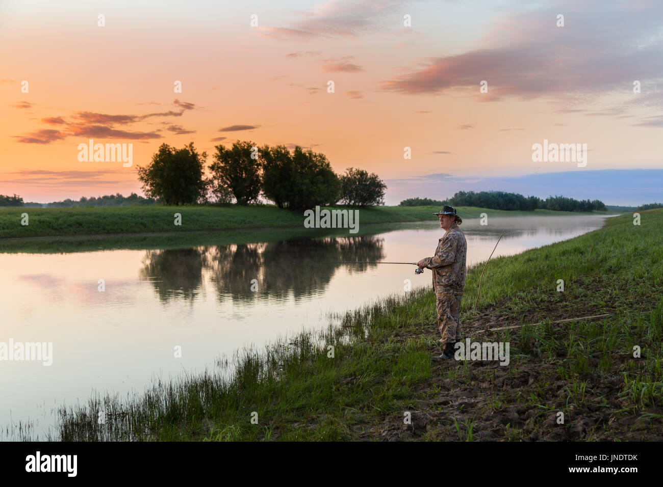 Pike hunter on the river Stock Photo - Alamy