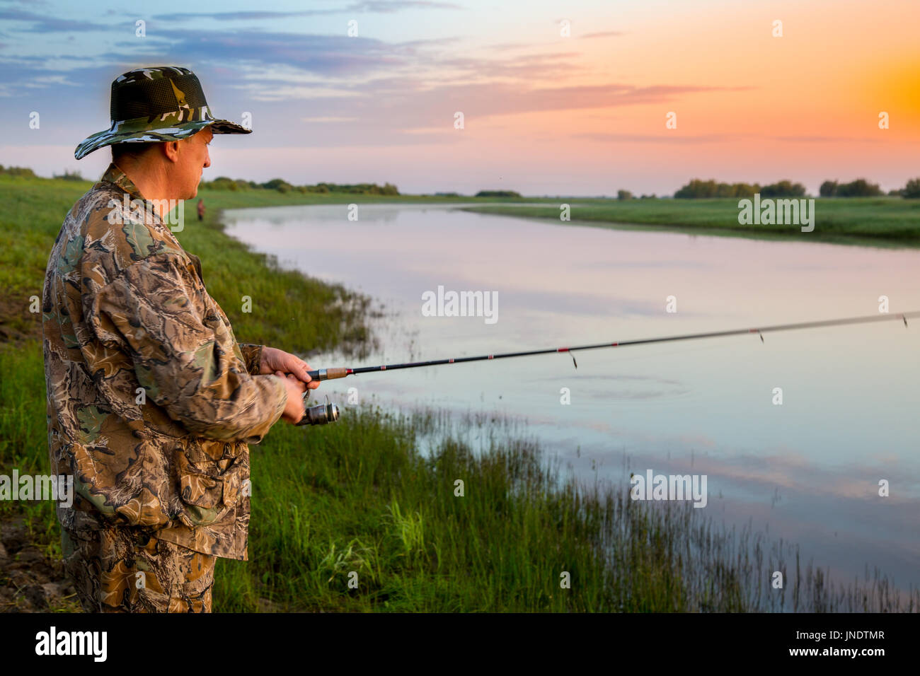 Pike hunter on the river Stock Photo - Alamy