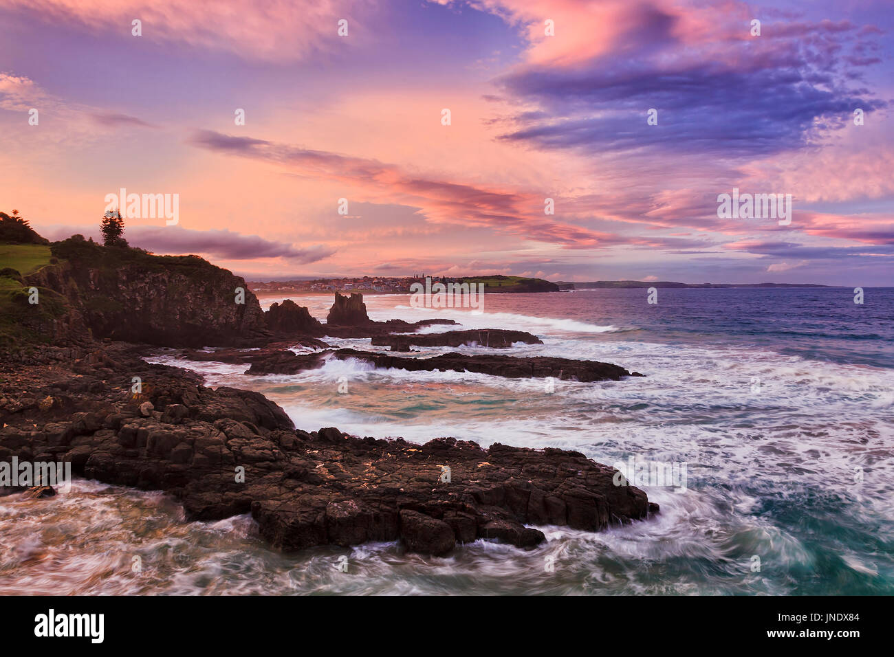 Colourful sunset over Australian pacific coast of Bombo Quarry ...