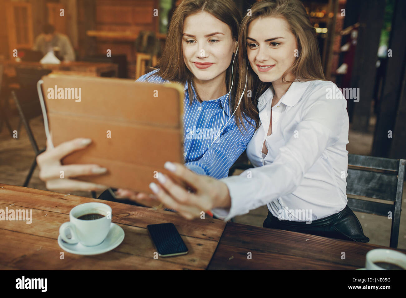 two girls in a cafe Stock Photo - Alamy