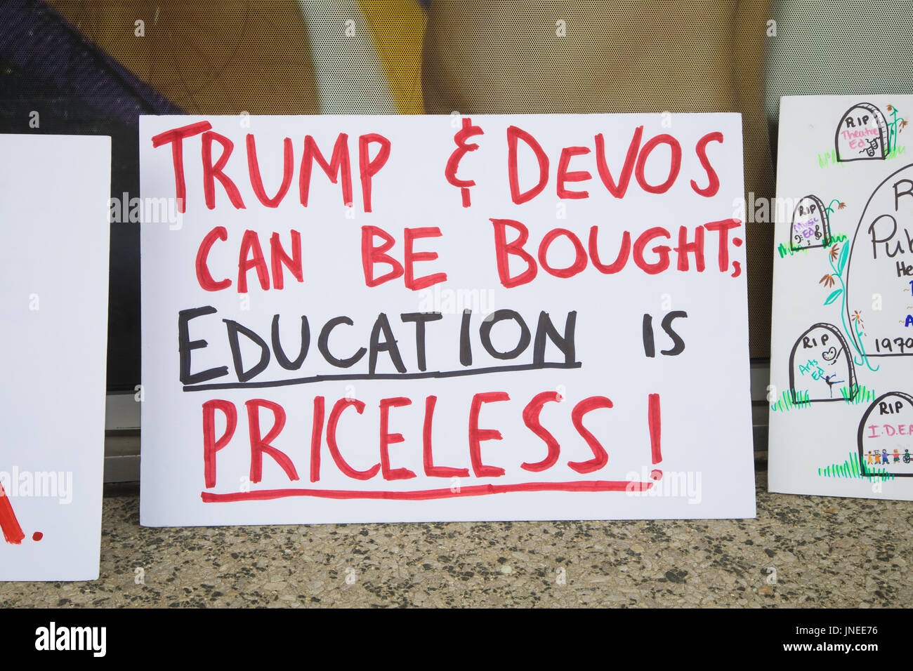 Protest signs left at the Department of Education by participants in ...