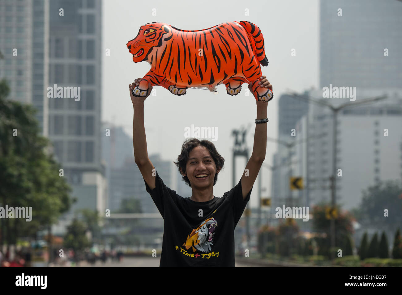 Jakarta, Indonesia. 30th July, 2017. A man pose with a tiger balloon ...