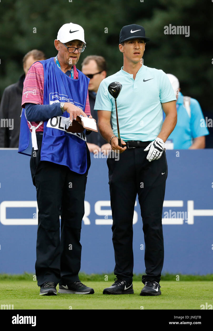 Thorbjorn Olesen from Denmark talks to his caddie during the 4th round ...