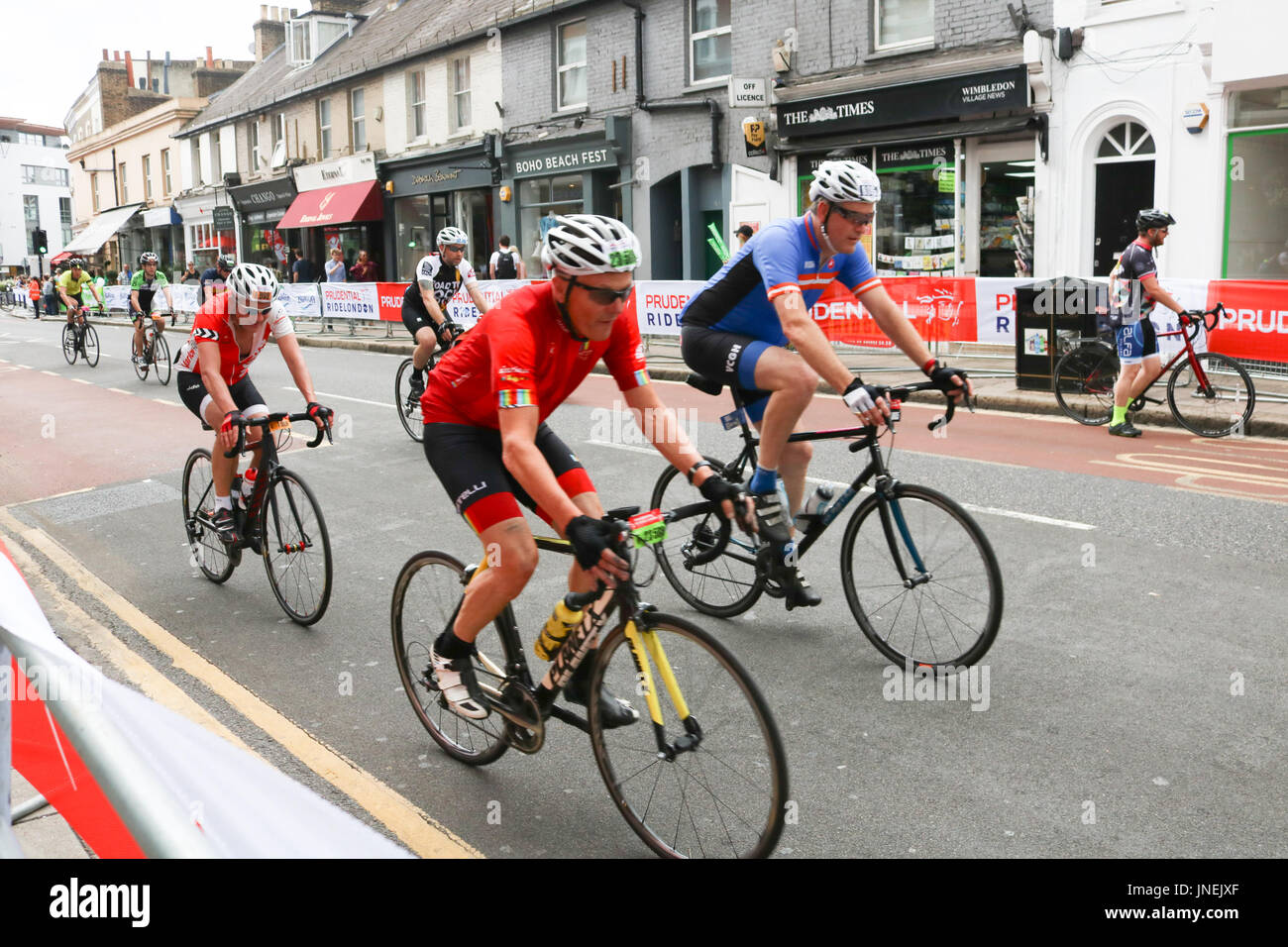 London, UK. 30th July, 2017. Riders pass through Wimbledon village as ...
