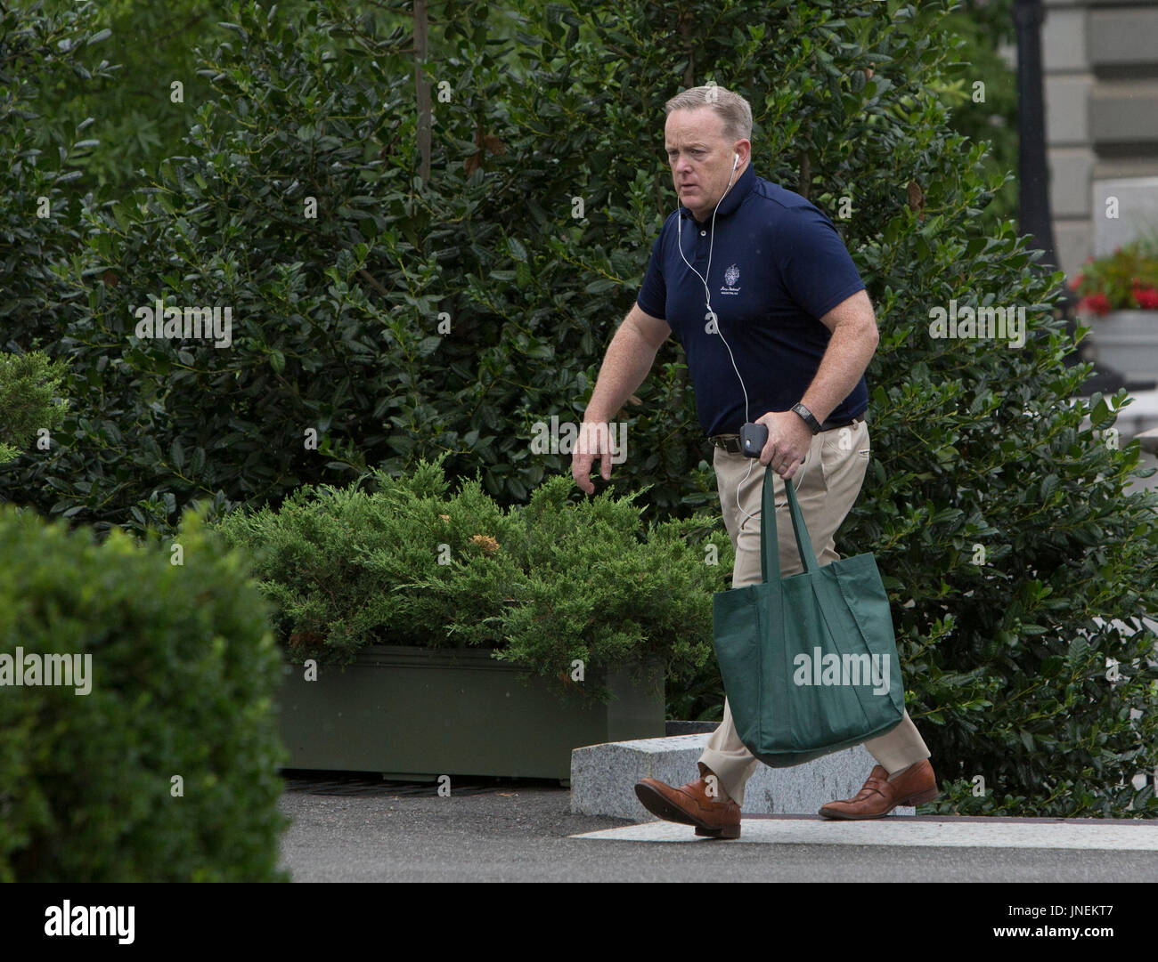 Outgoing White House Press Secretary Sean Spicer walks into the West ...