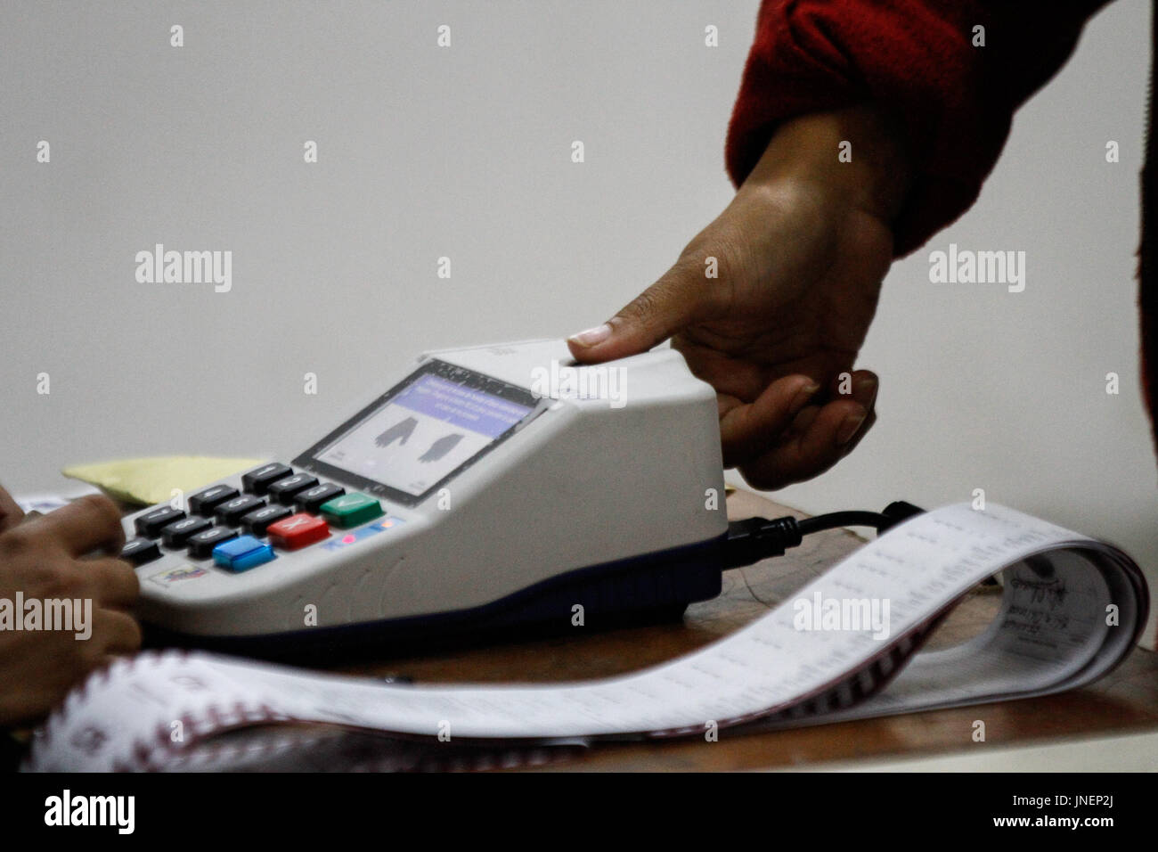 Caracas, Venezuela. 30th July, 2017. A voter registers fingerprint ...