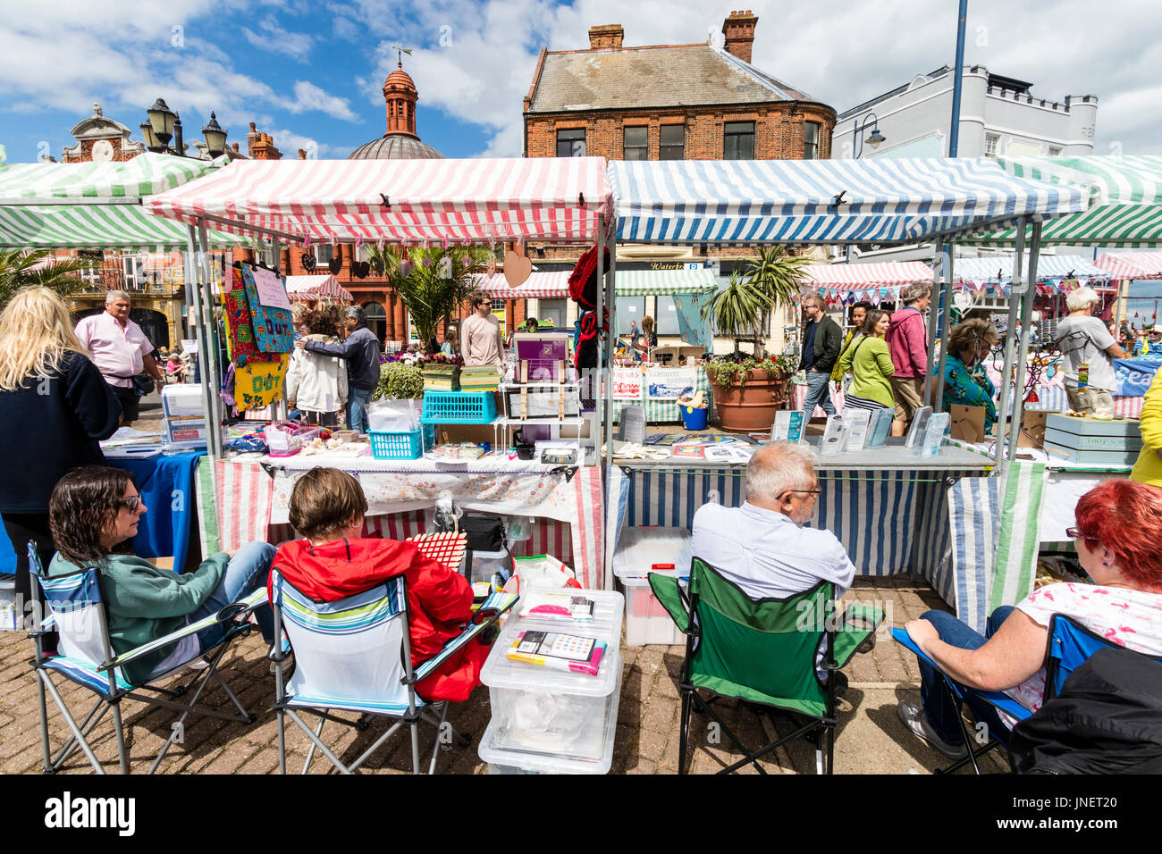 English market. Stalls selling handicrafts, seen from behind, with ...