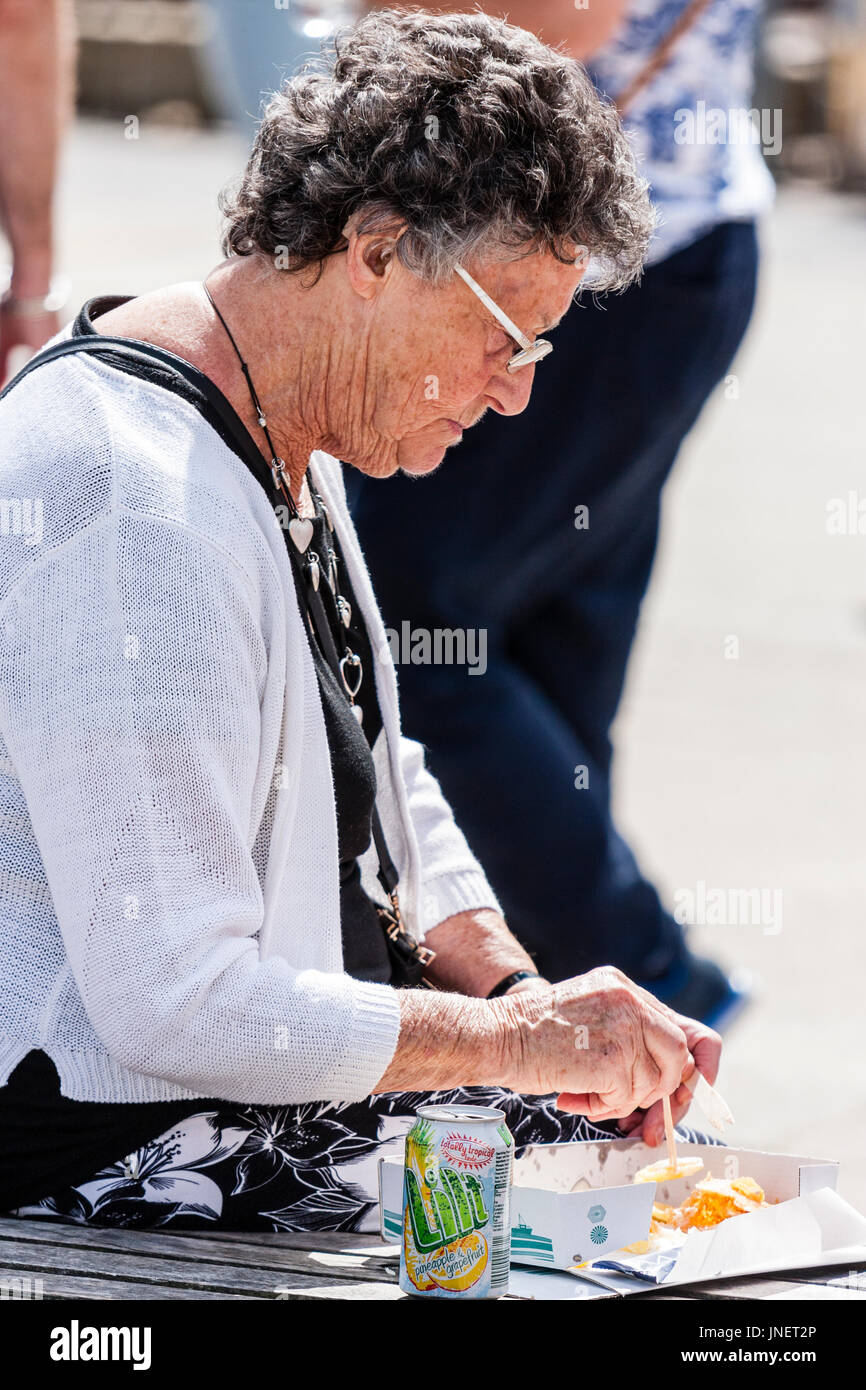 Senior woman eating fish hi-res stock photography and images - Alamy