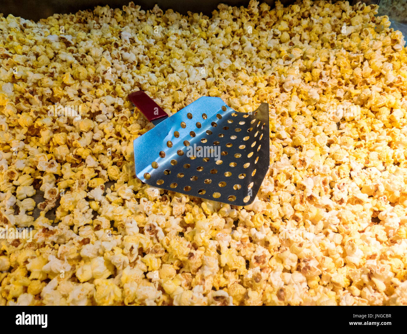 Popcorn with serving scoop Stock Photo - Alamy