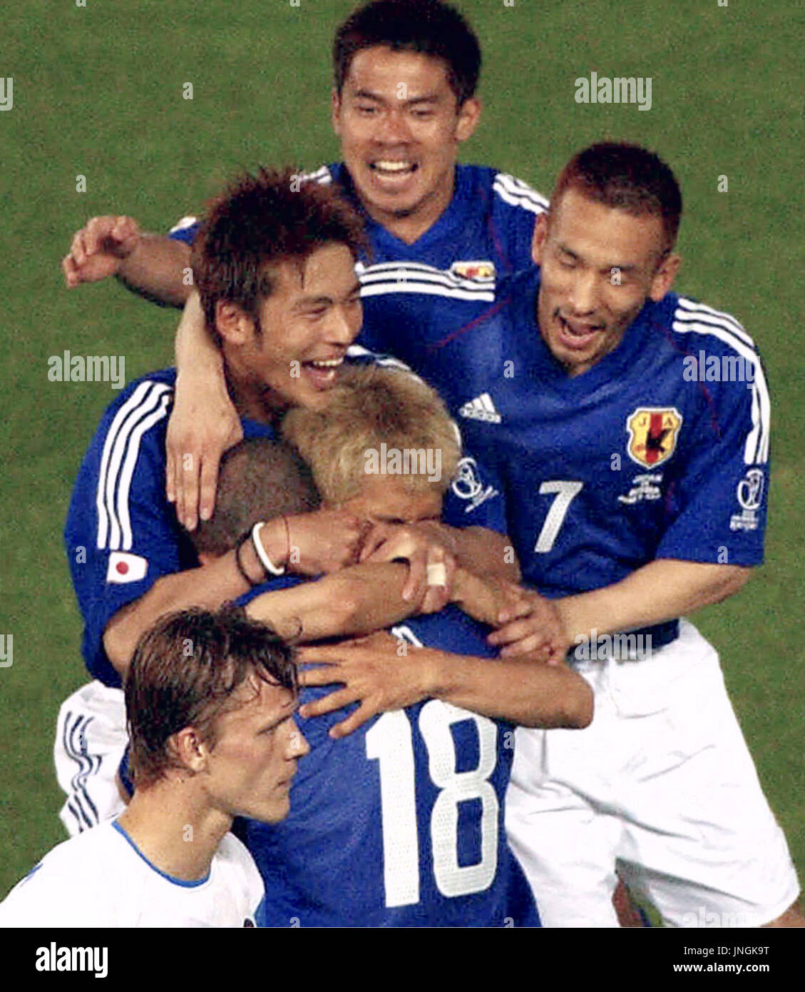 YOKOHAMA, Japan - Japan's Junichi Inamoto (C) is mugged by teammates ...