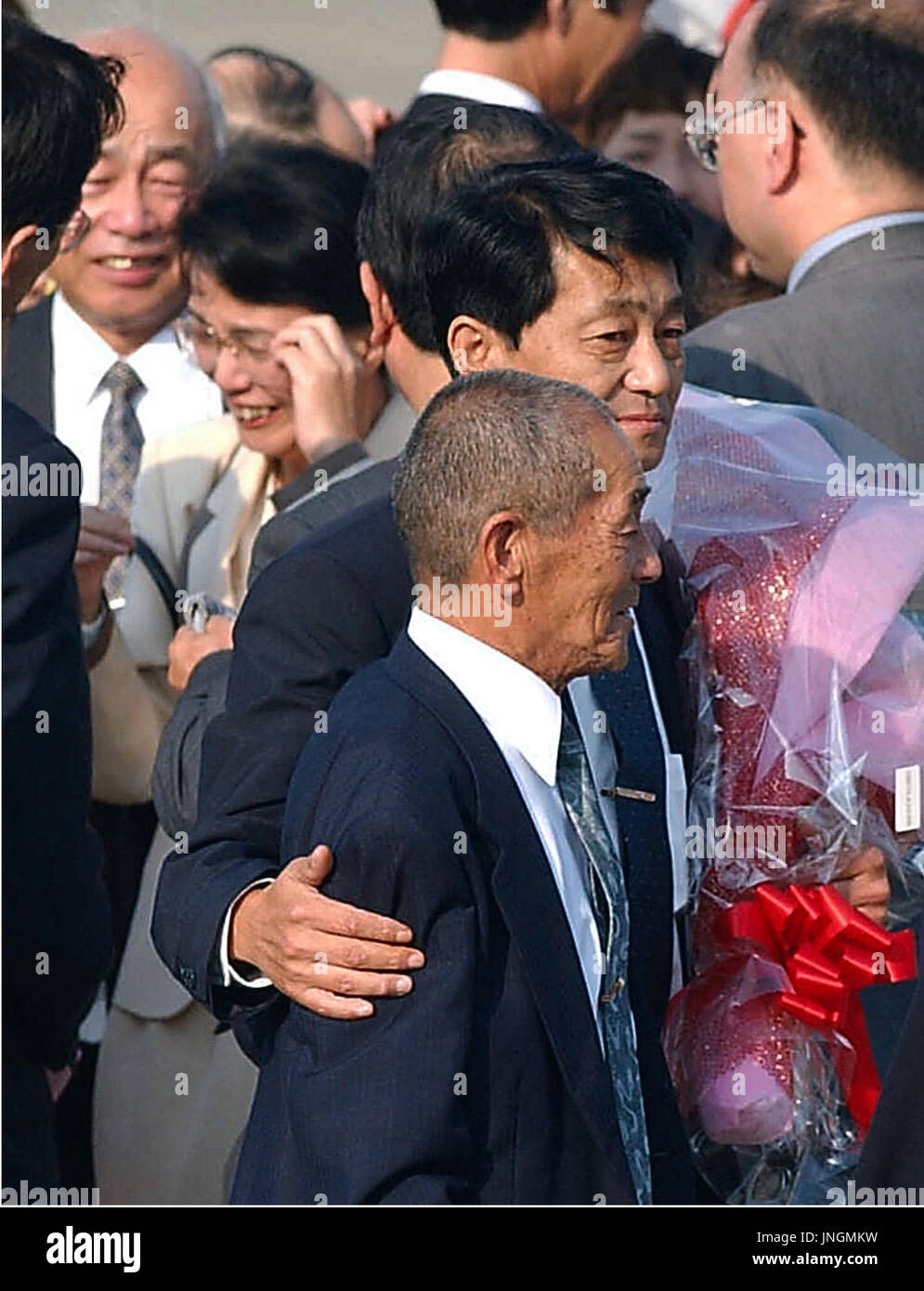 TOKYO, Japan - Yasushi Chimura holds his father Tamotsu on arriving at ...
