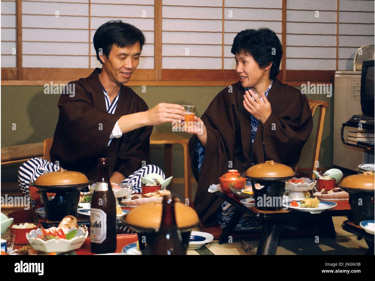 MYOKOKOGEN, Japan - Kaoru Hasuike (L) and his wife Yukiko Okudo raise their glasses in a toast ...