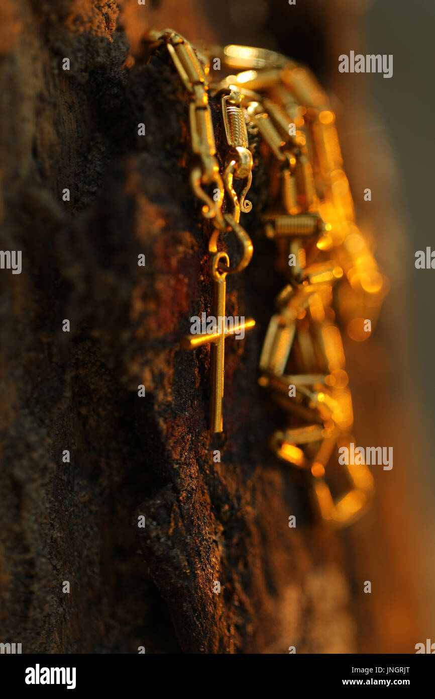 a golden cross on a chain for marriage Stock Photo - Alamy