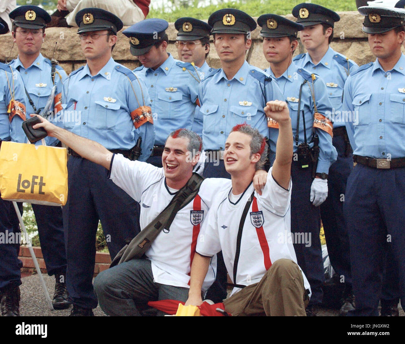NIIGATA, Japan - Two England supporters pose for a photograph with a ...