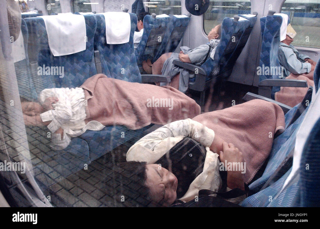 TOKYO, Japan - Passengers sleep in a train at JR Tokyo Station early ...