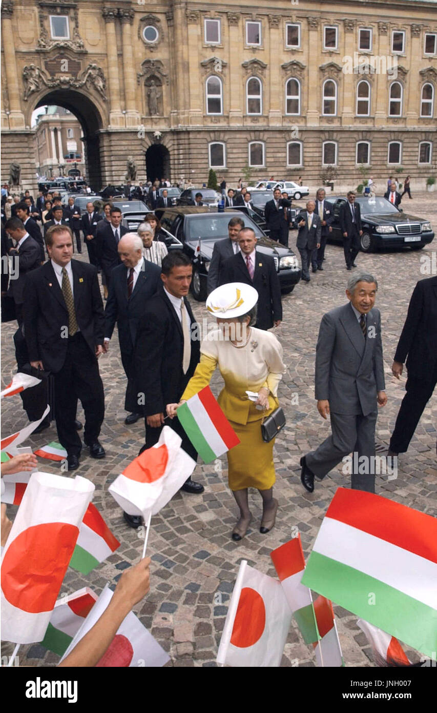 BUDAPEST, Hungary - Empress Michiko picks up a flag dropped by one of ...