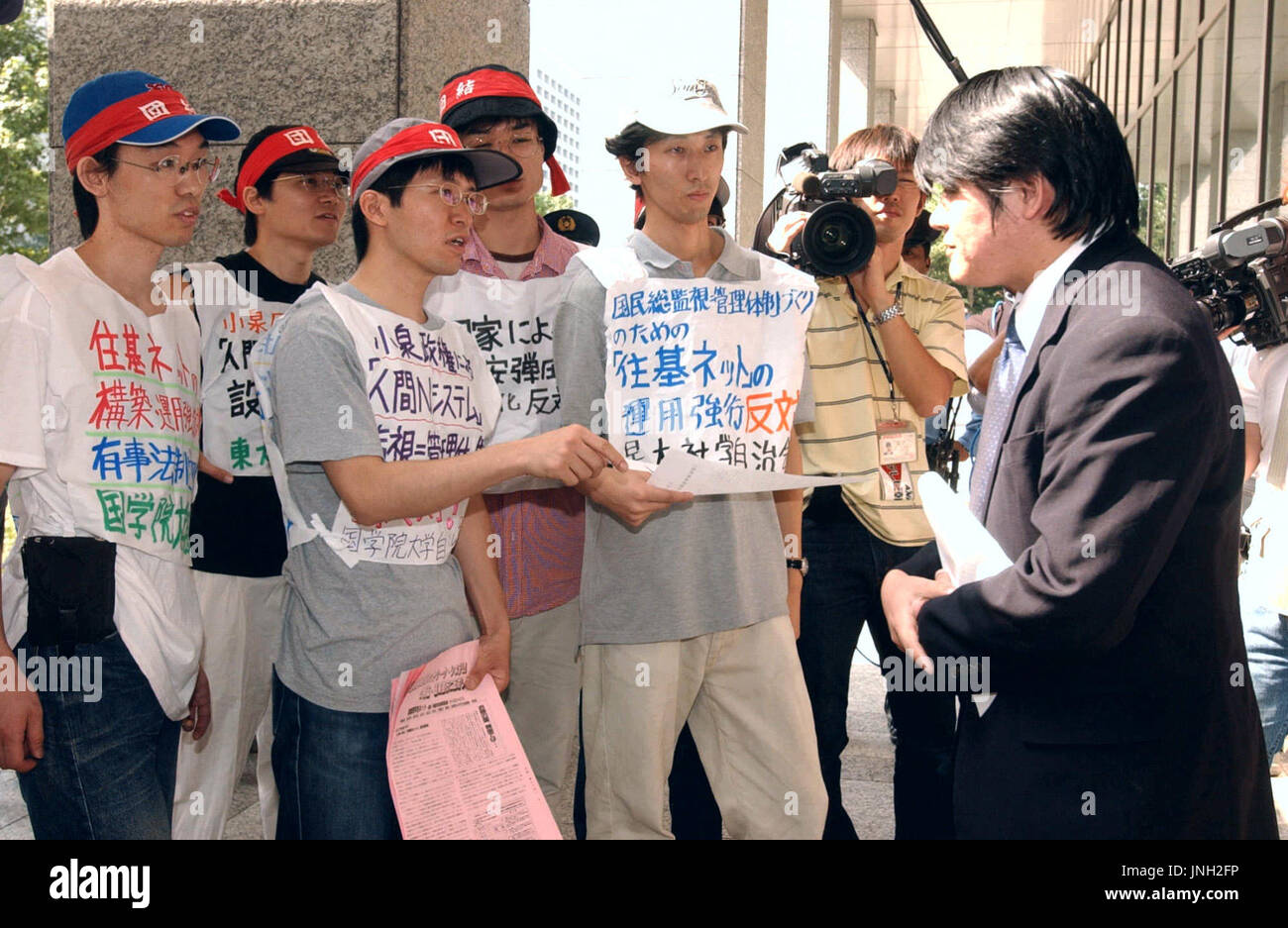 TOKYO, Japan - Student protests in front of a government official (R ...