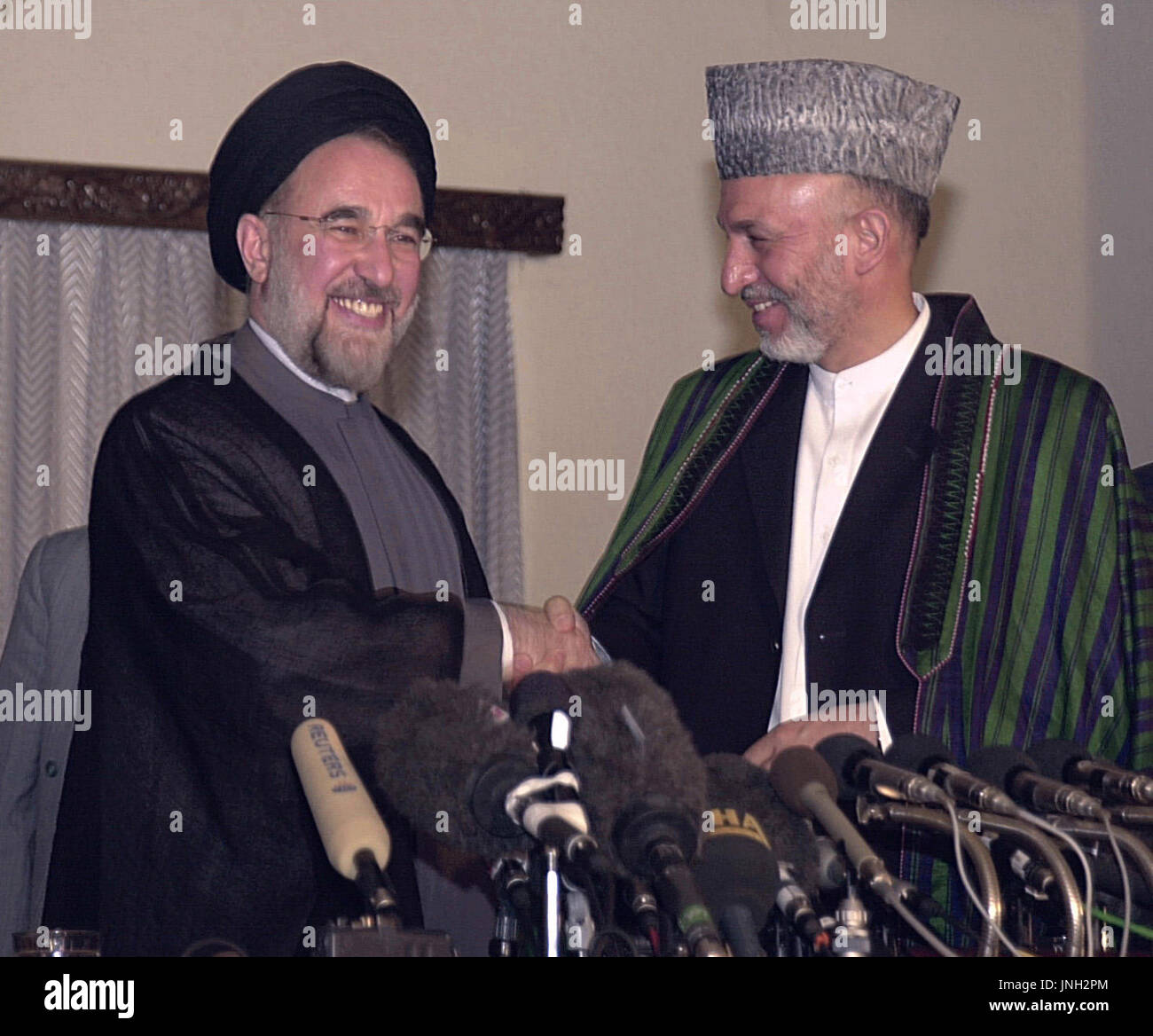 KABUL, Afghanistan - Afghan President Hamid Karzai (R) shakes hands ...