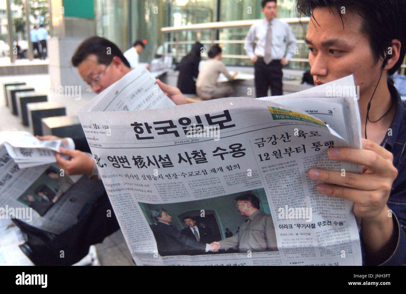 SEOUL, South Korea - A Seoul citizen reads a newspaper reporting the ...
