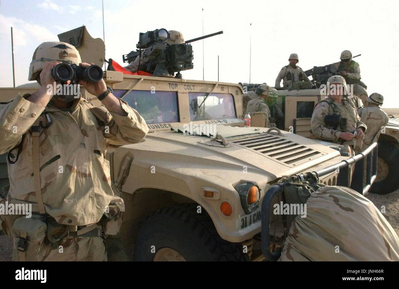 KUWAIT - A U.S. soldier watches the movement of assault helicopters ...