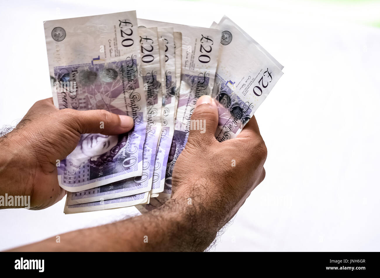 Counting Twenty pounds notes Stock Photo - Alamy