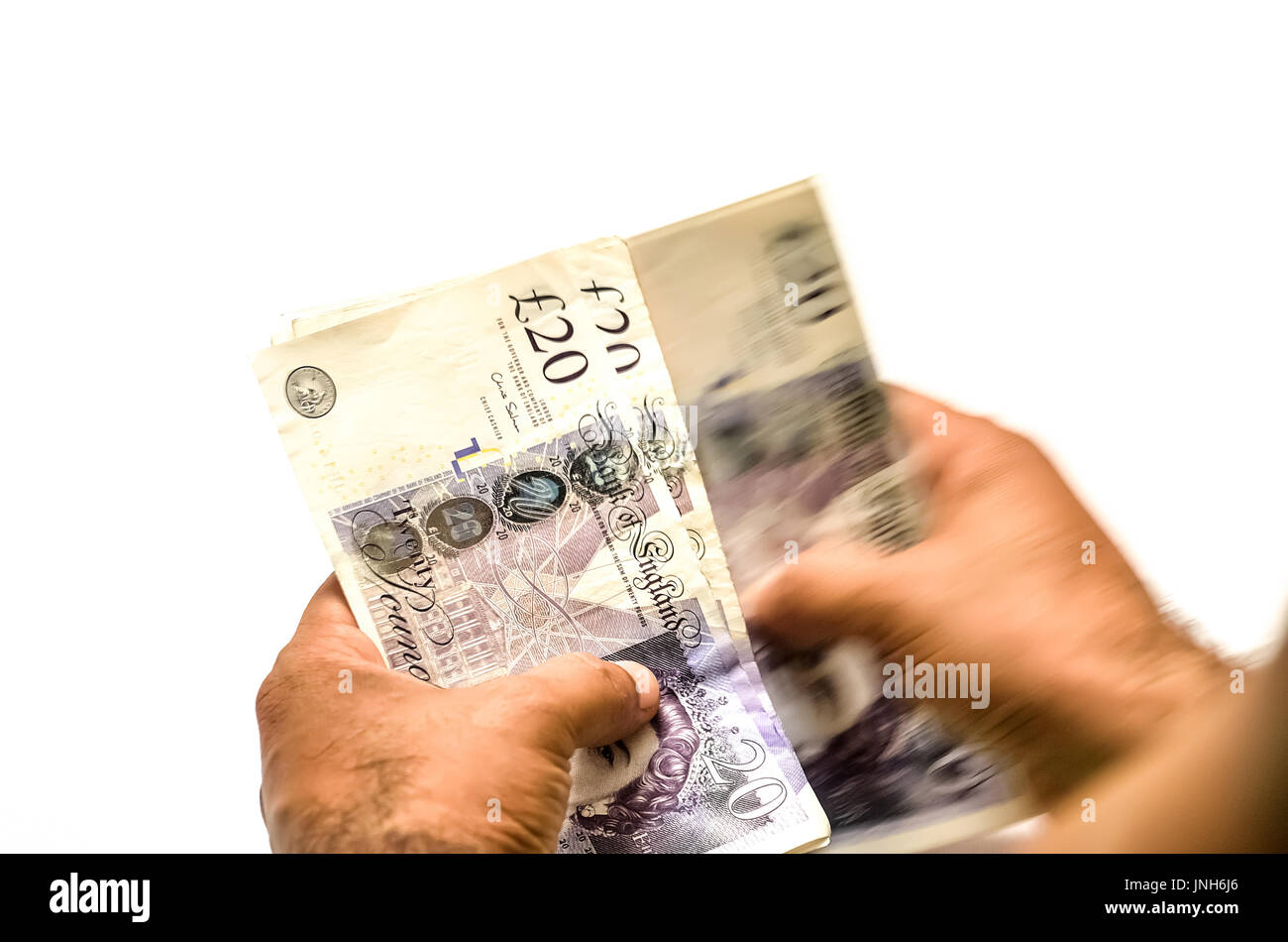Counting Twenty pounds notes Stock Photo - Alamy