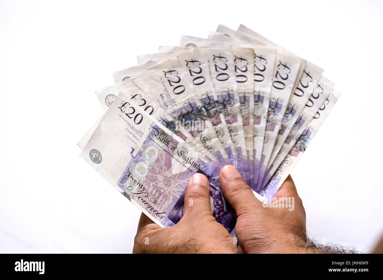 Counting Twenty pounds notes Stock Photo - Alamy
