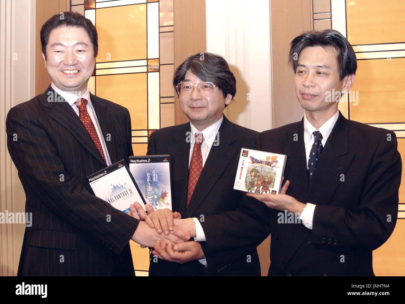 TOKYO, Japan - Square Co. President Yoichi Wada (L) and Enix Corp ...