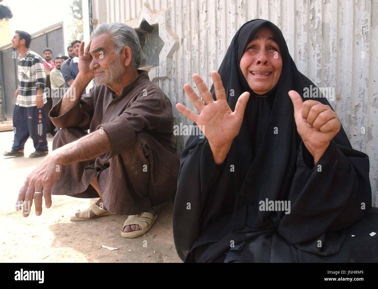 BAGHDAD, Iraq - A woman cries in front of the Iraqi military ...