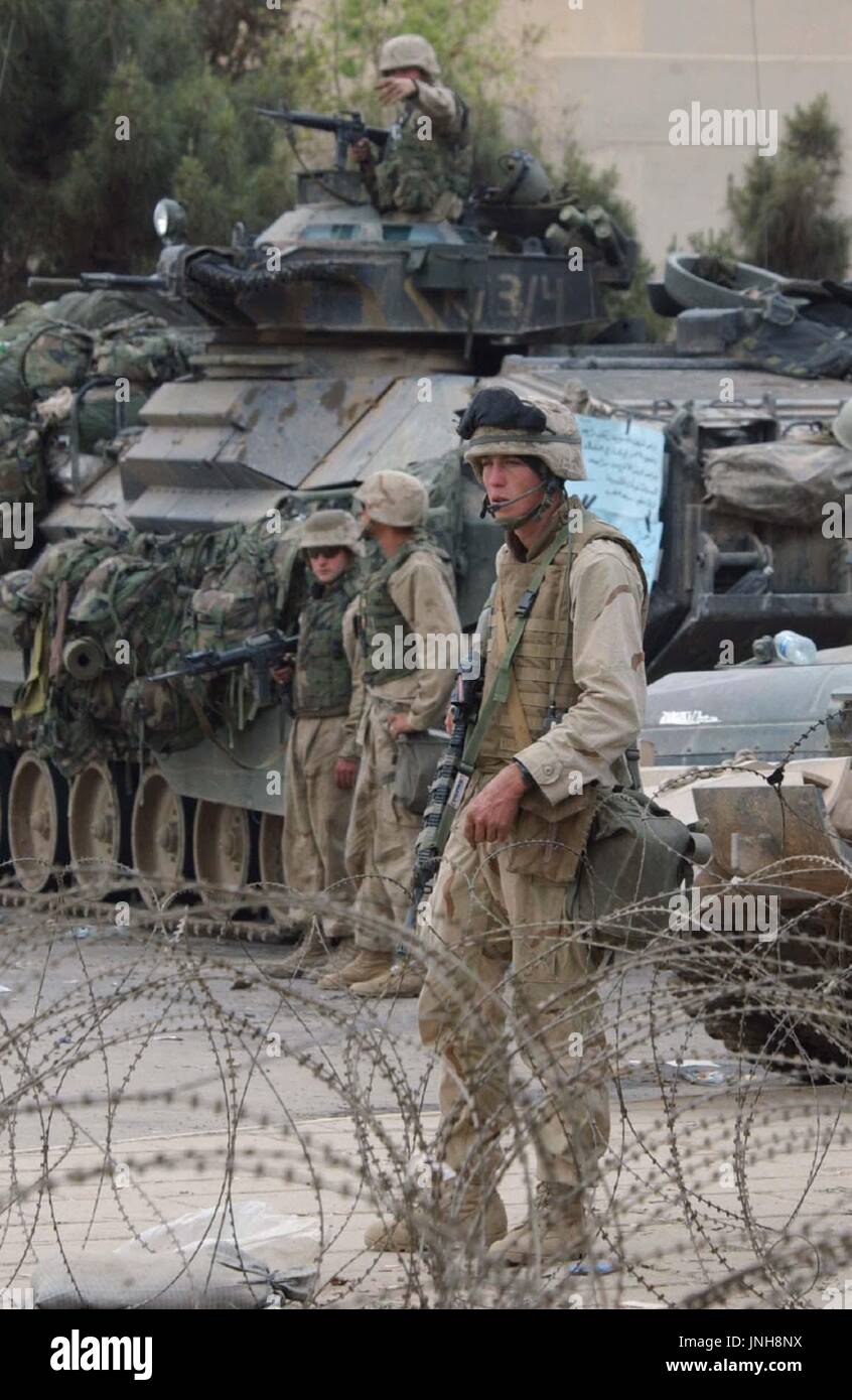 BAGHDAD, Iraq - U.S. soldiers stand guard by barbed roadblocks in ...