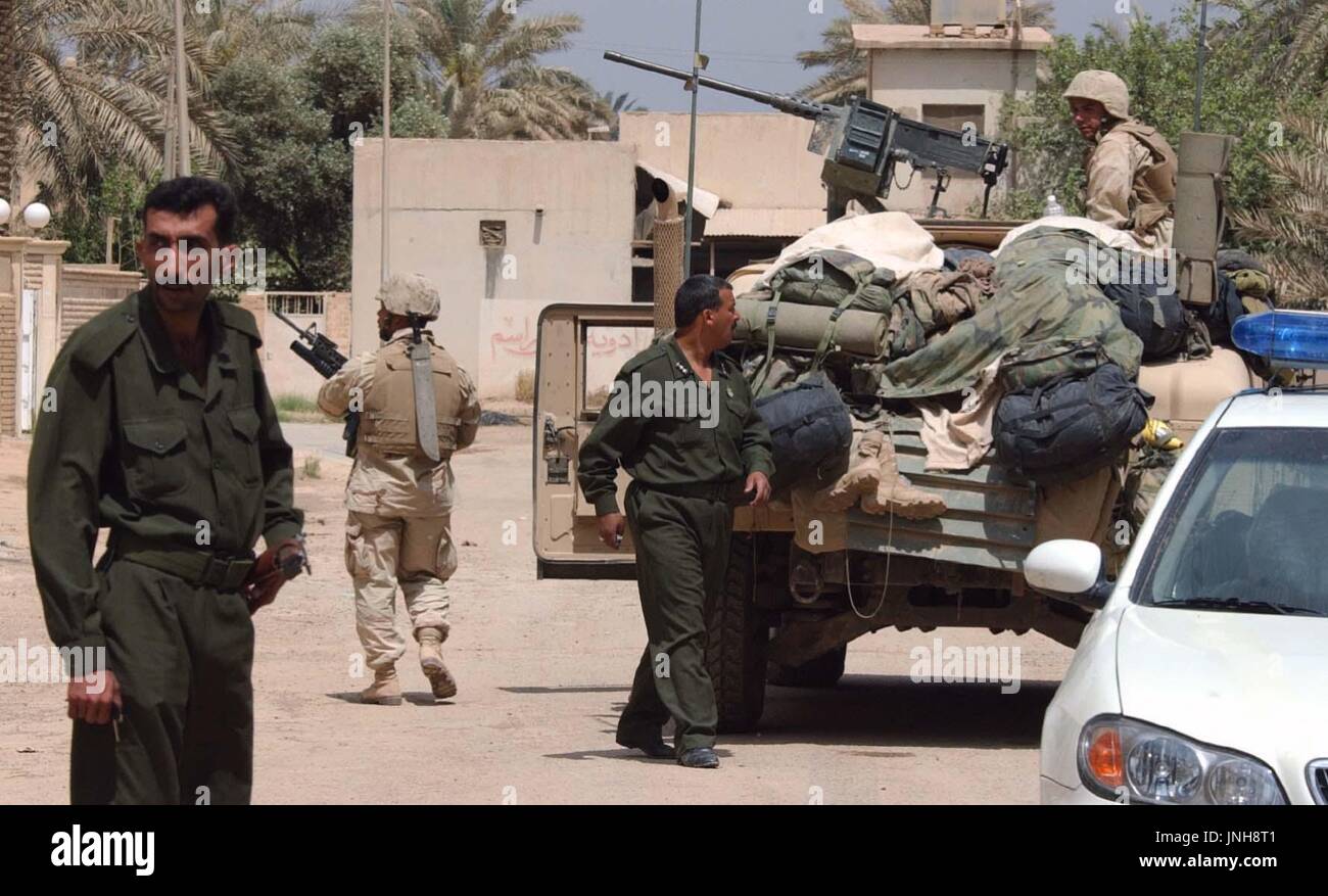 BAGHDAD, Iraq - Iraqi police officers and U.S. soldiers cooperate in ...