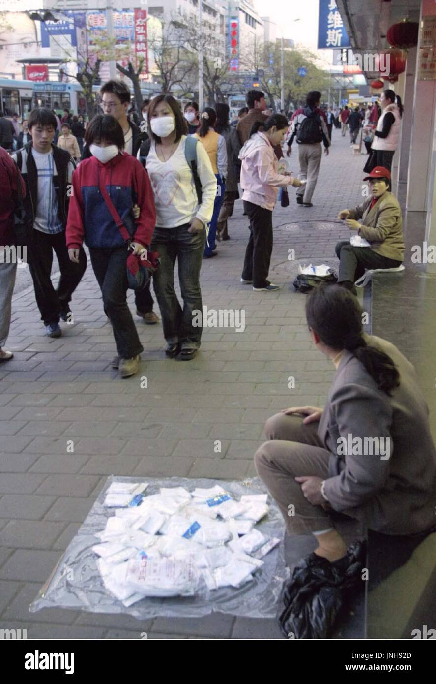 BEIJING, China - A street vender sells protective masks against the ...