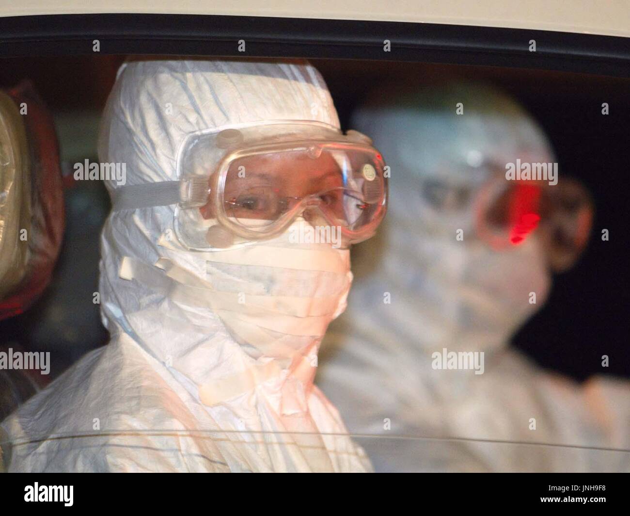 BEIJING, China - Medical staff wearing protective clothing transport ...