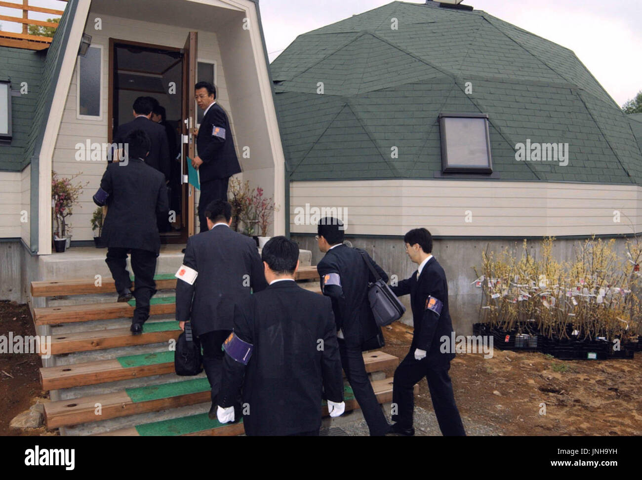 OIZUMI, Japan - Police enter a Pana Wave Laboratory facility in the ...