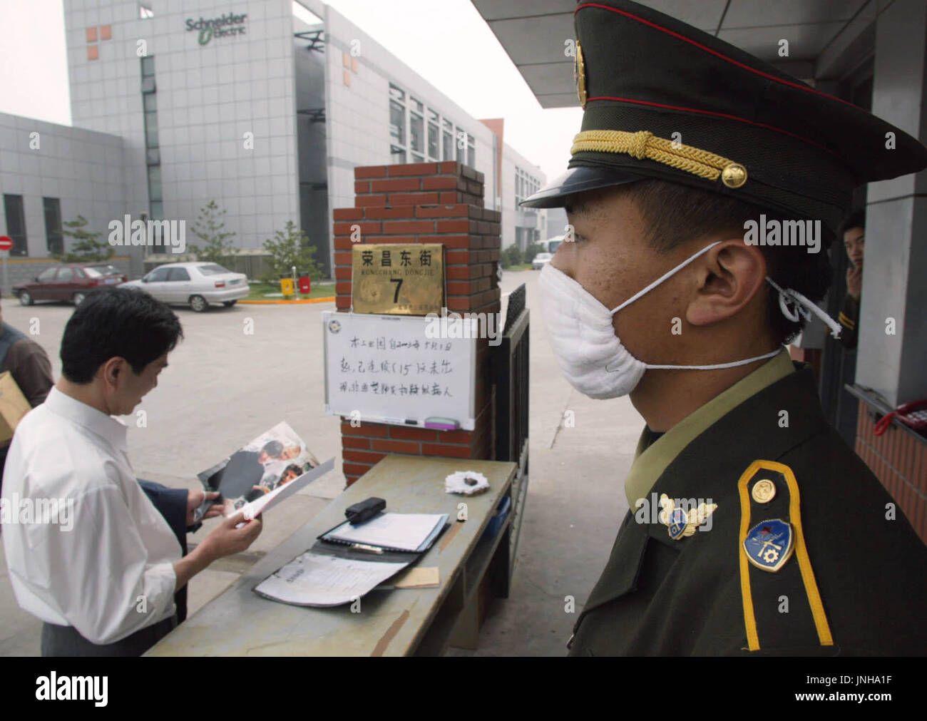 BEIJING, China - A security guard wears a face mask to protect himself ...