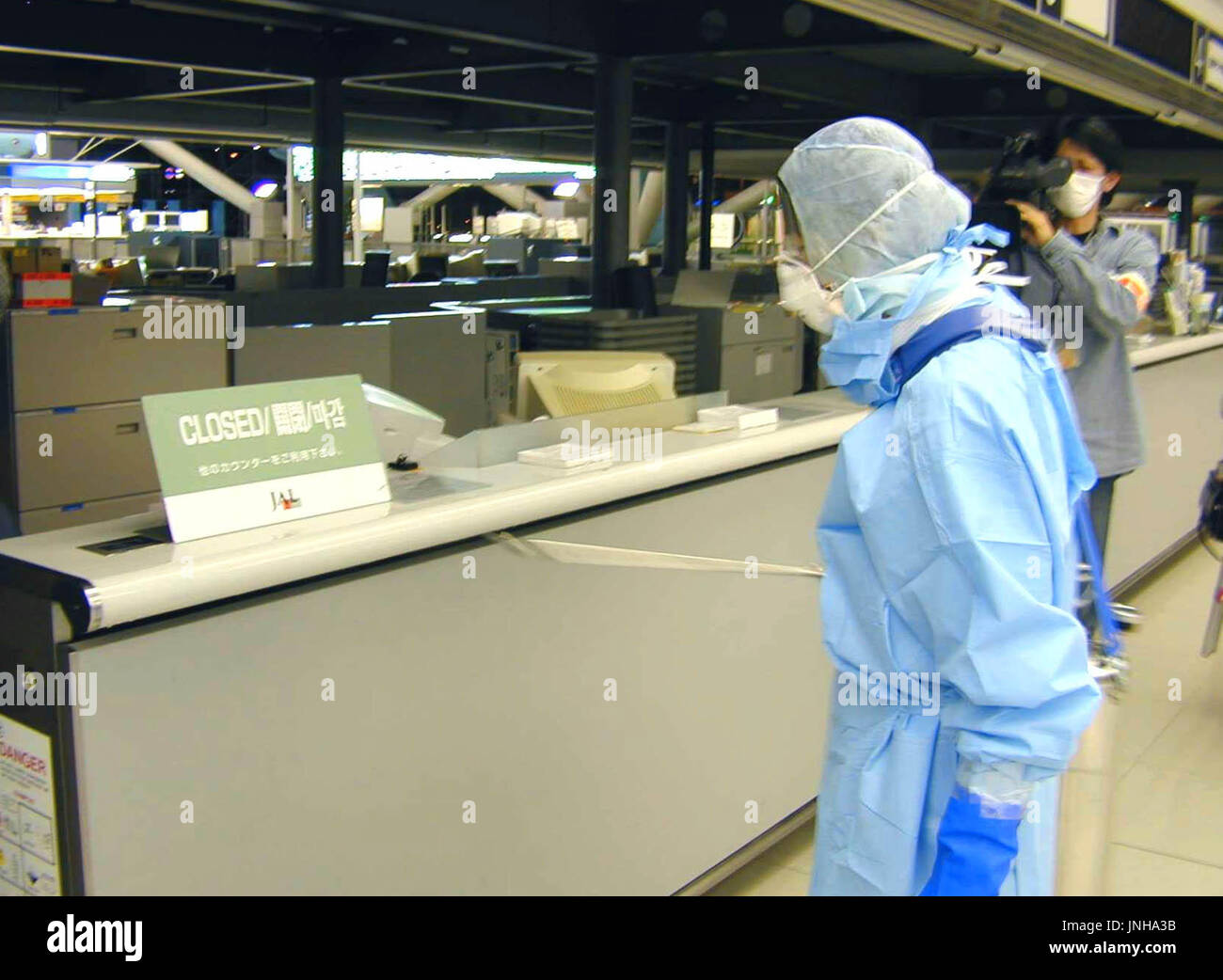 OSAKA, Japan - A health official disinfects a counter at Kansai ...