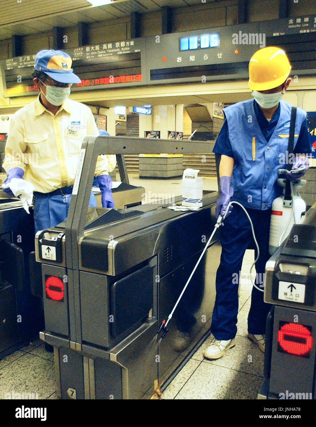 OSAKA, Japan - Workers disinfect automatic ticket gates at JR Osaka ...