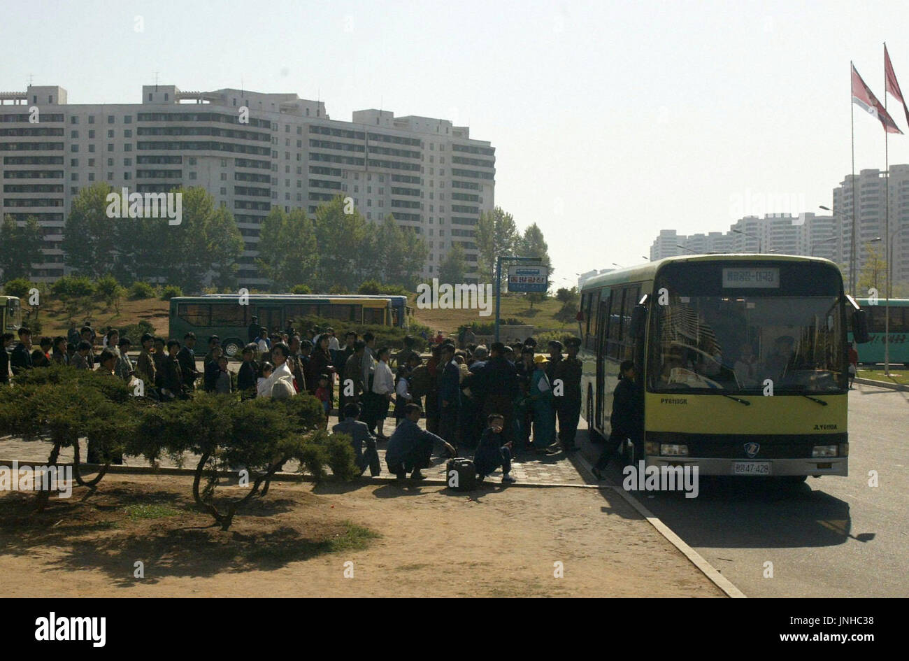 TOKYO, Japan - Commuters line up for bus in downtown Pyongyang. The ...