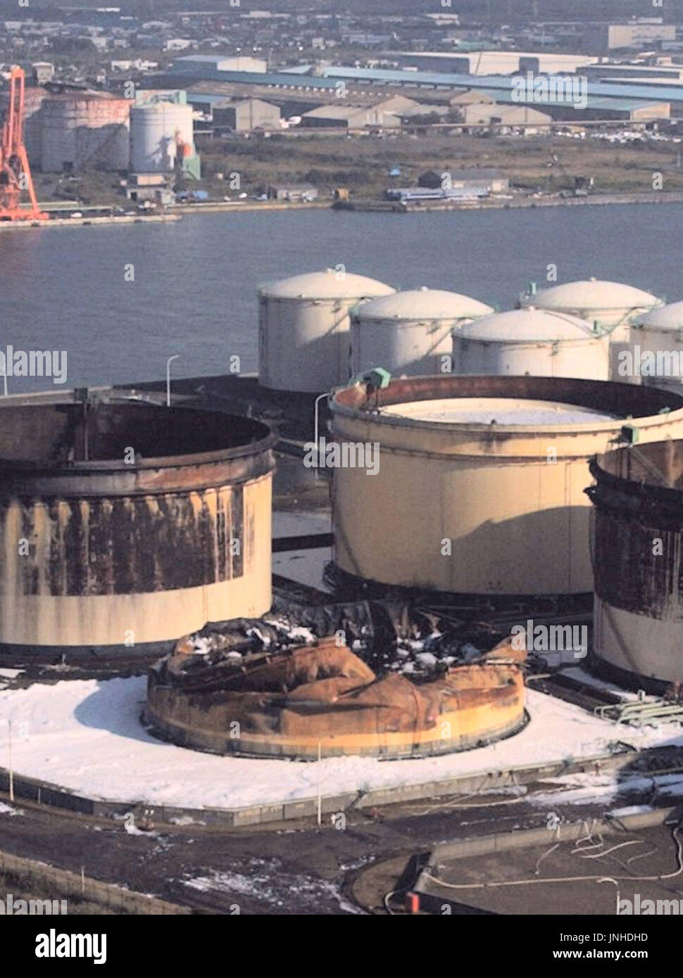 TOMAKOMAI, Japan - The charred remains of a naphtha tank (front) at the ...