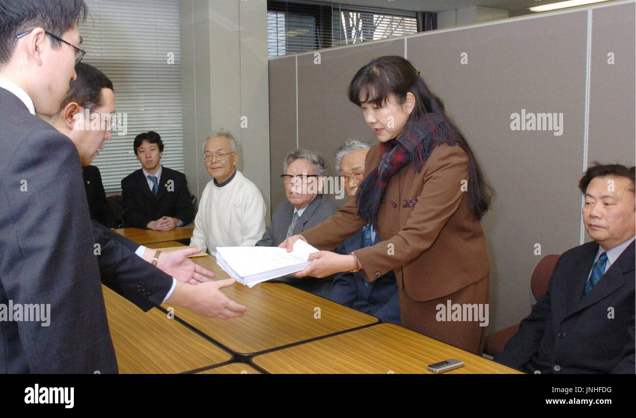 KUMAMOTO, Japan - Lawyer Naoko Kunimune (2nd from R) hands applications ...