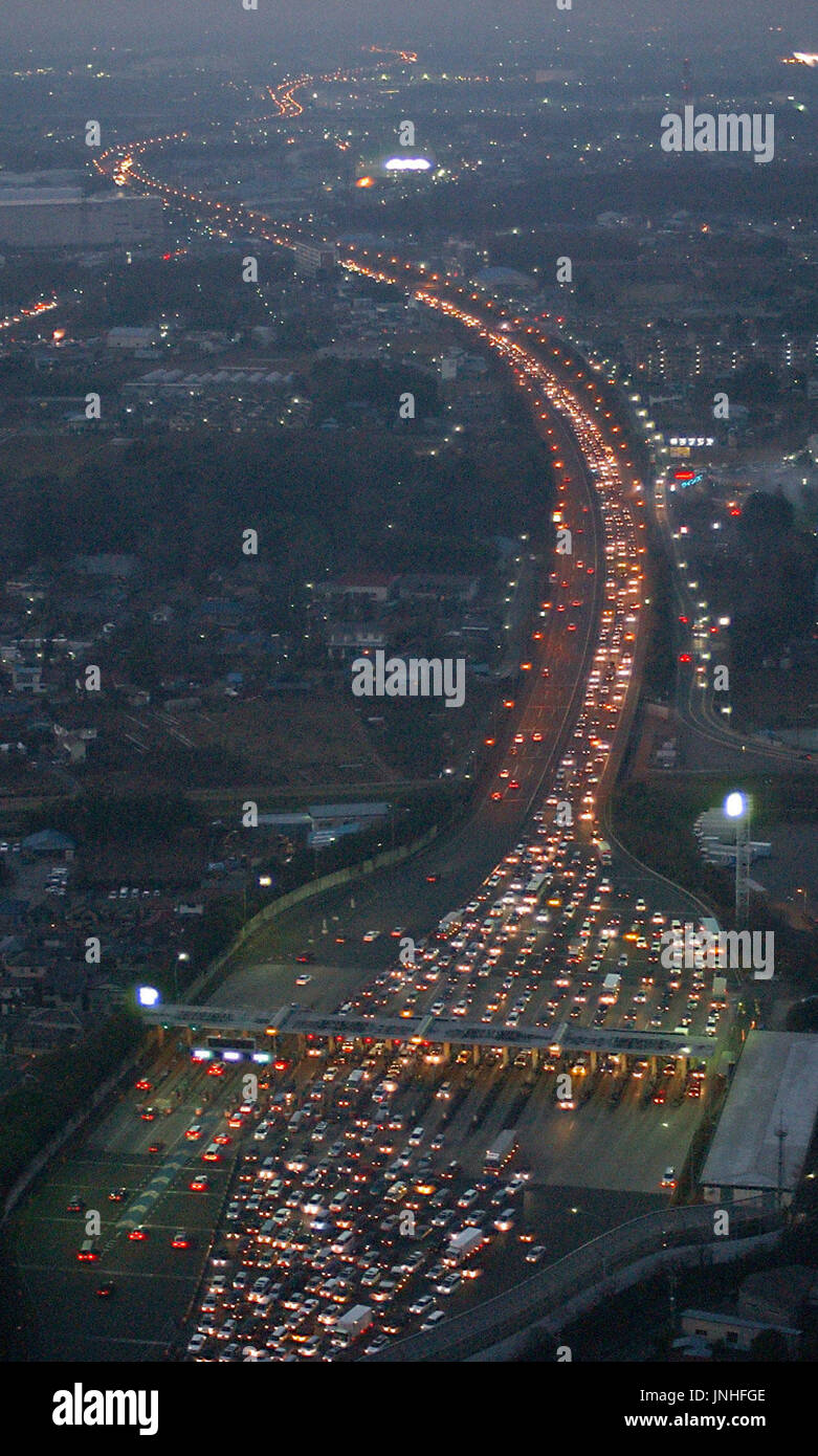 TOKYO, Japan - Long lines of vehicle lights are seen near a toll gate ...