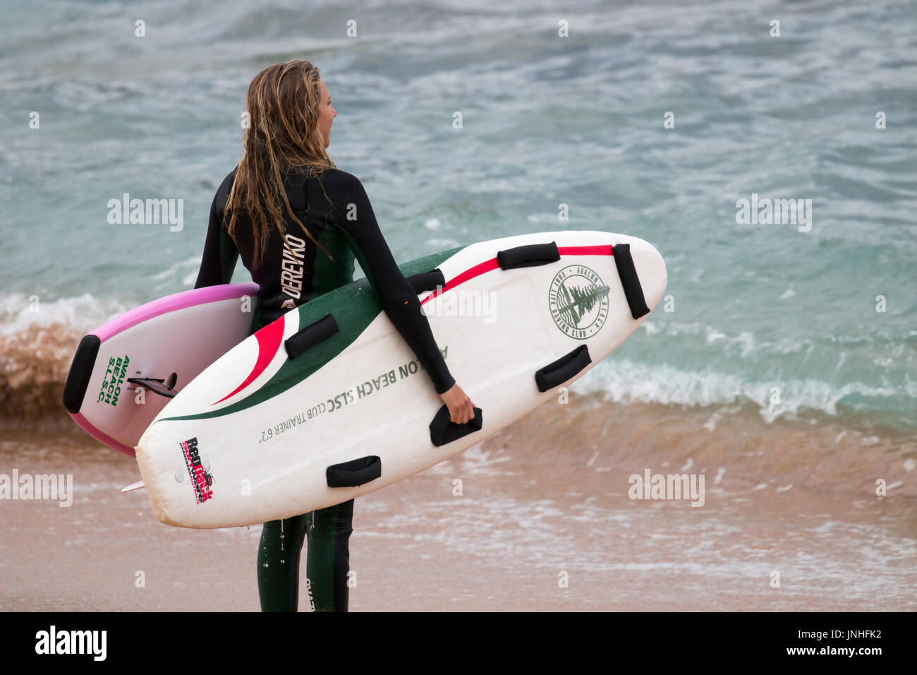 Two young surfers on the beach holding their surfboards hi-res stock ...